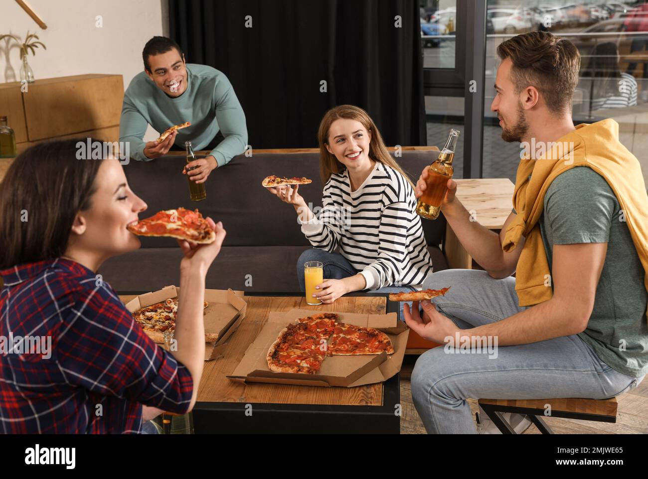 Group of friends having fun party with delicious pizza in cafe Stock ...