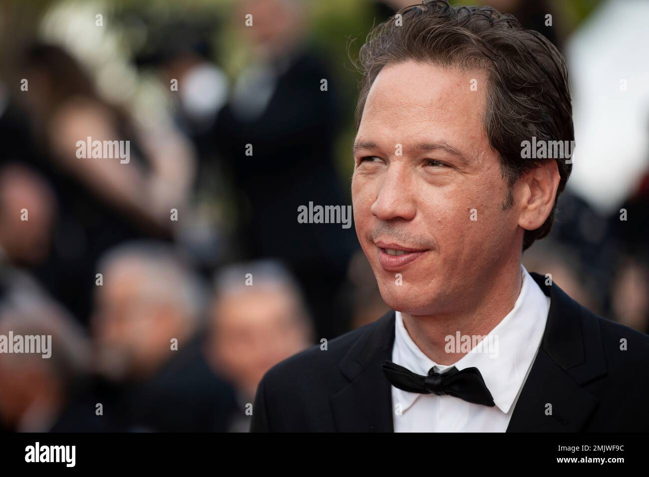 Reda Kateb poses for photographers upon arrival at the awards ceremony ...