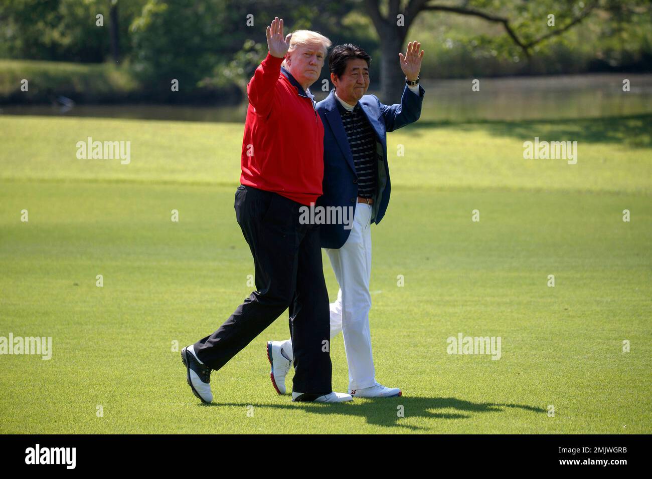 President Donald Trump walks with Japanese Prime Minister Shinzo Abe ...