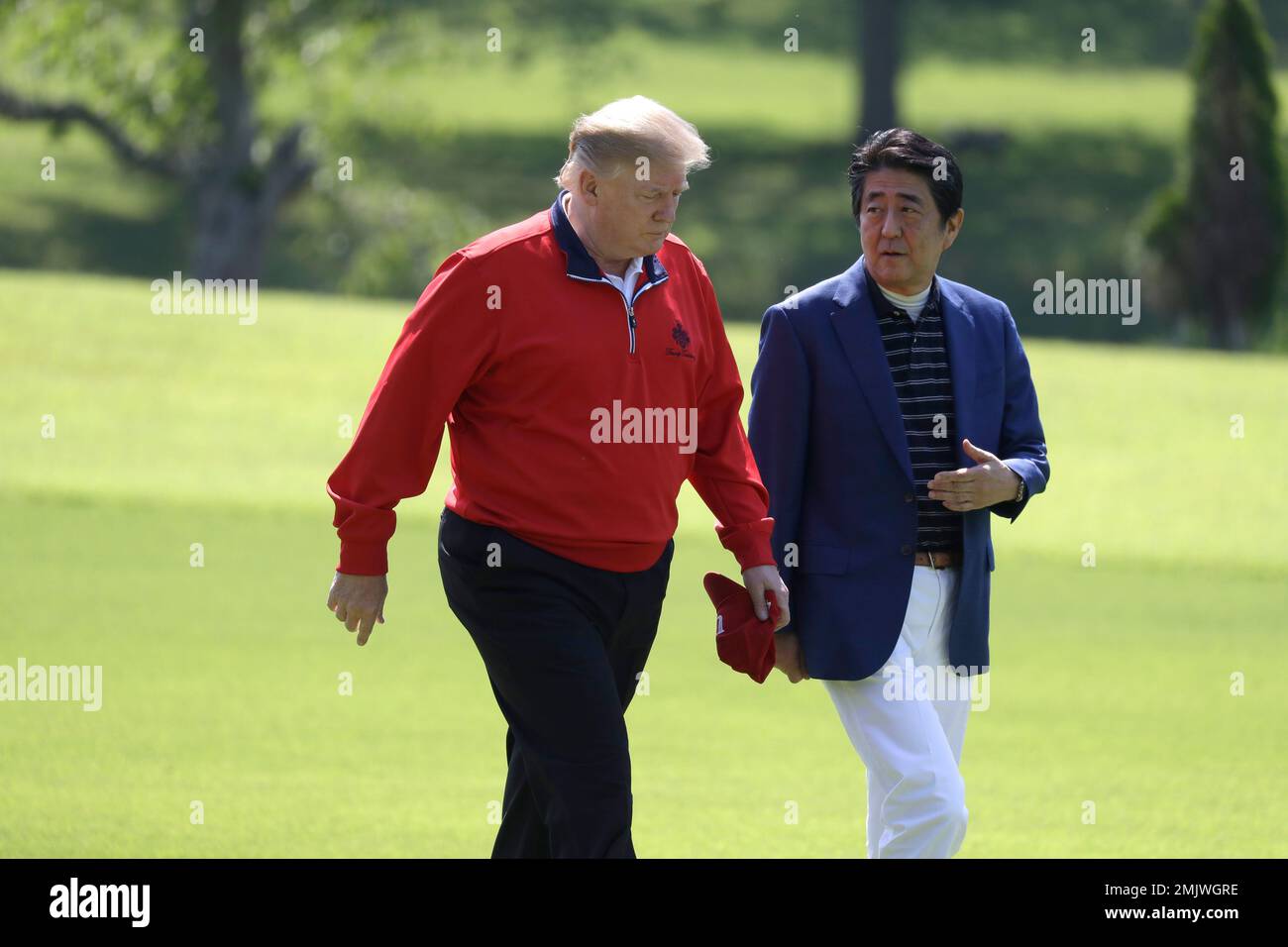 President Donald Trump walks with Japanese Prime Minister Shinzo Abe ...
