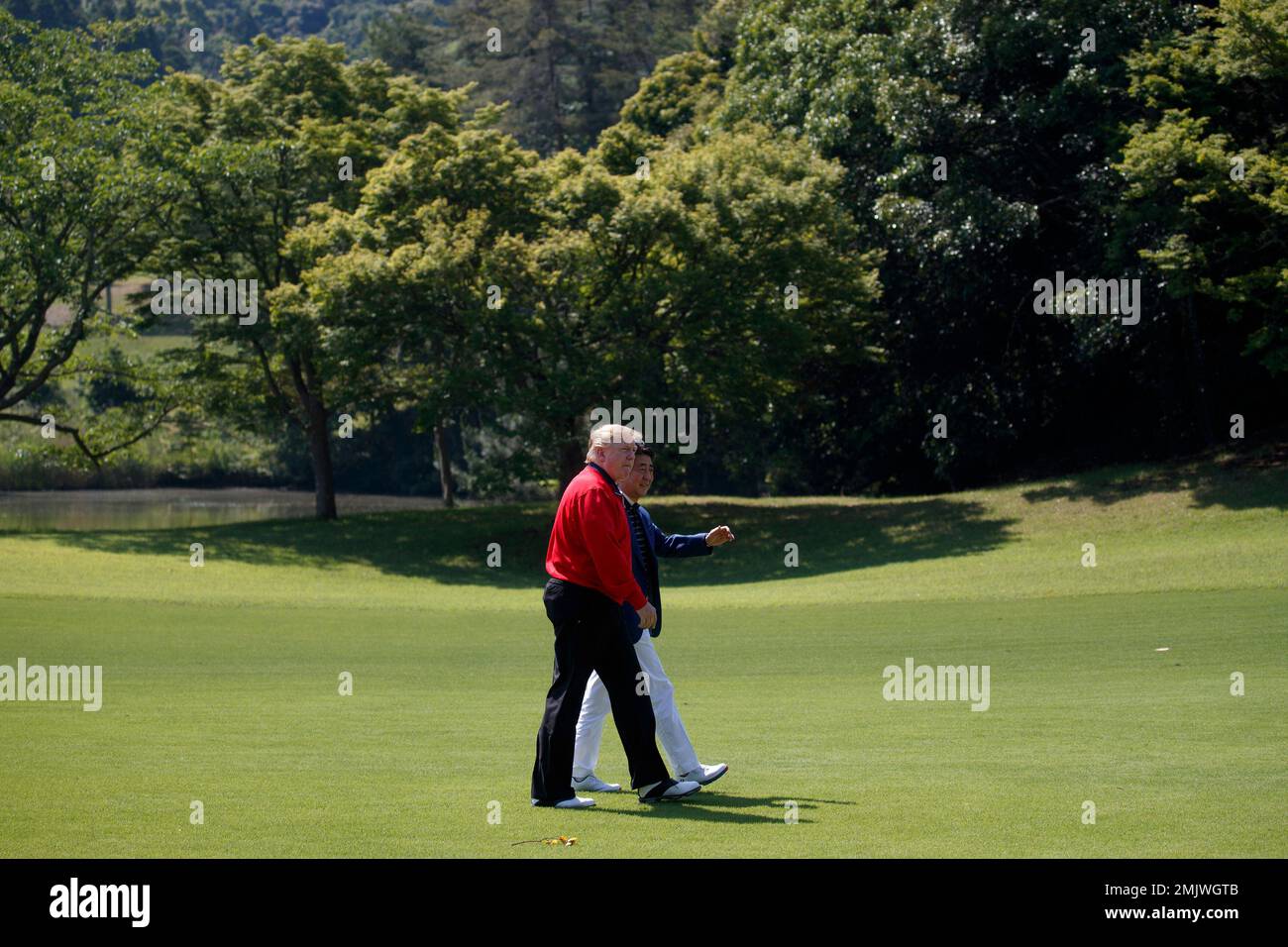 President Donald Trump walks with Japanese Prime Minister Shinzo Abe ...