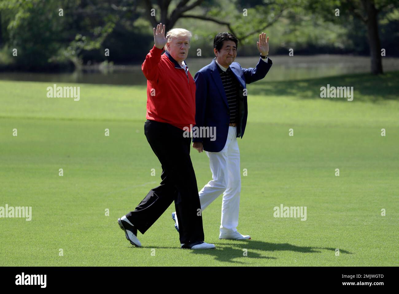 President Donald Trump walks with Japanese Prime Minister Shinzo Abe ...