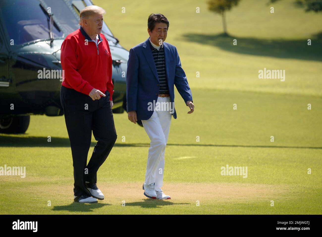 President Donald Trump walks with Japanese Prime Minister Shinzo Abe ...