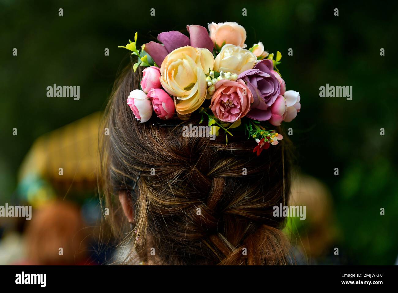 A devotee of the Rocio Virgin decorates her hair with flowers while ...