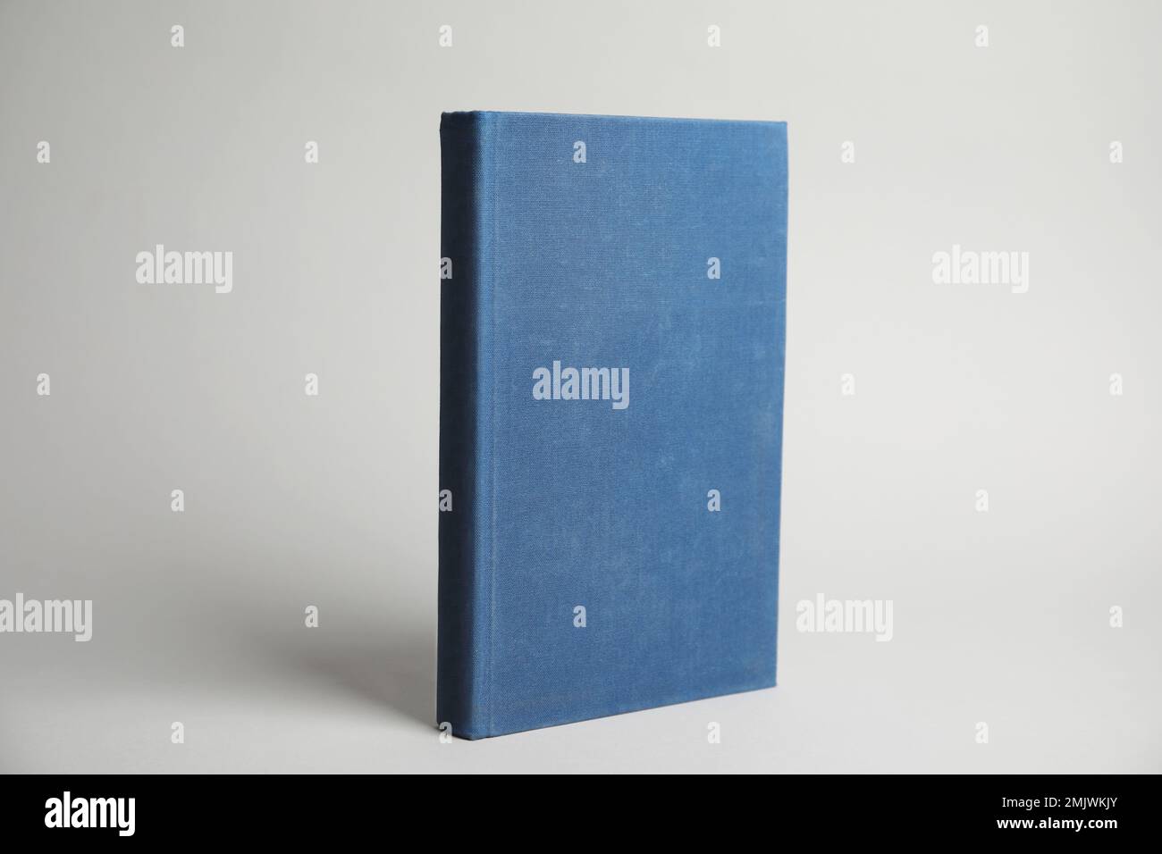 Hardcover book on light grey background. Space for design Stock Photo ...