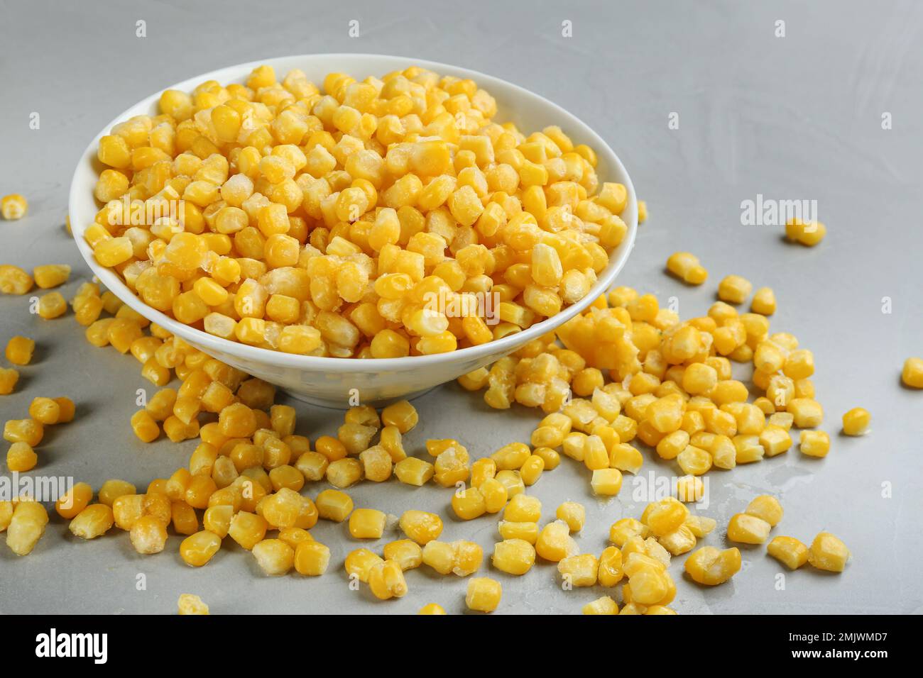 Frozen corn on light grey table. Vegetable preservation Stock Photo - Alamy