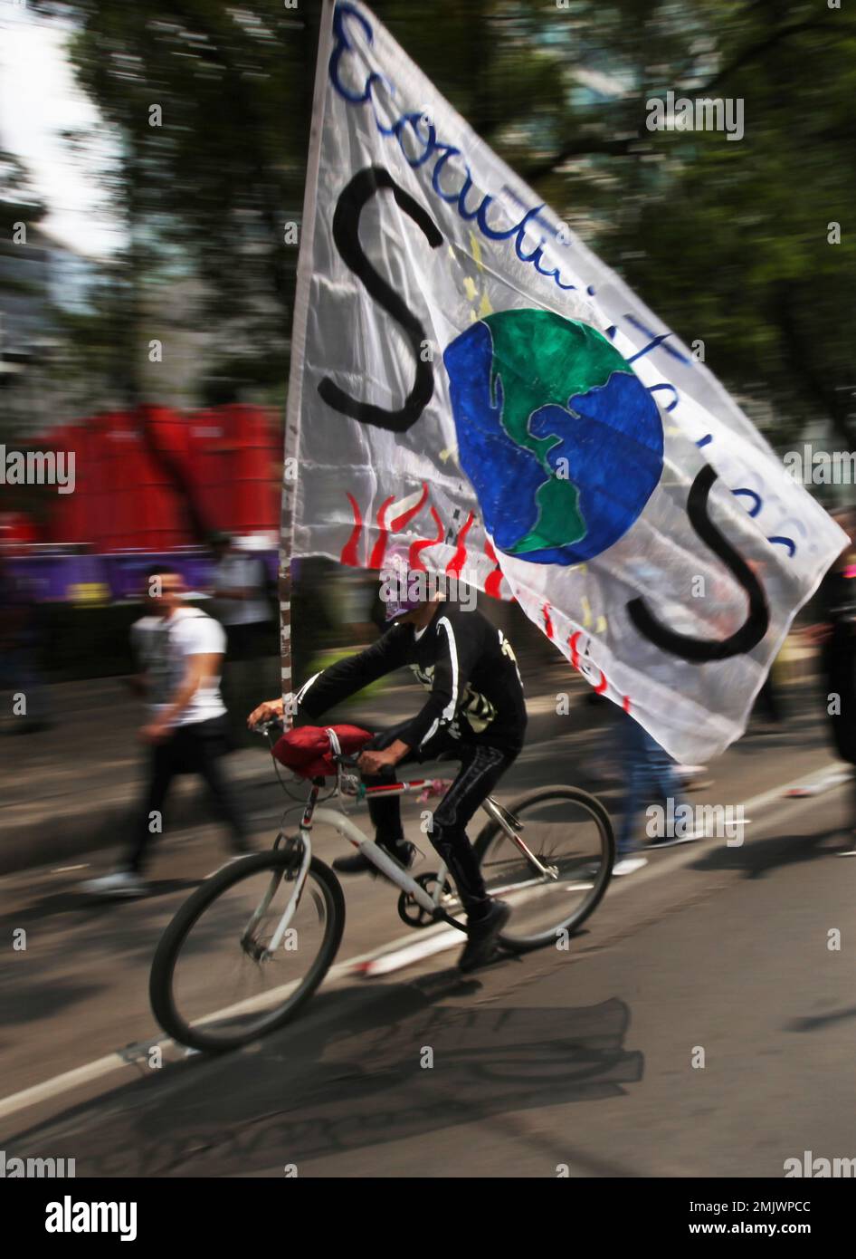 A climate demonstrator rides a bicycle during a protest at the Angel of ...