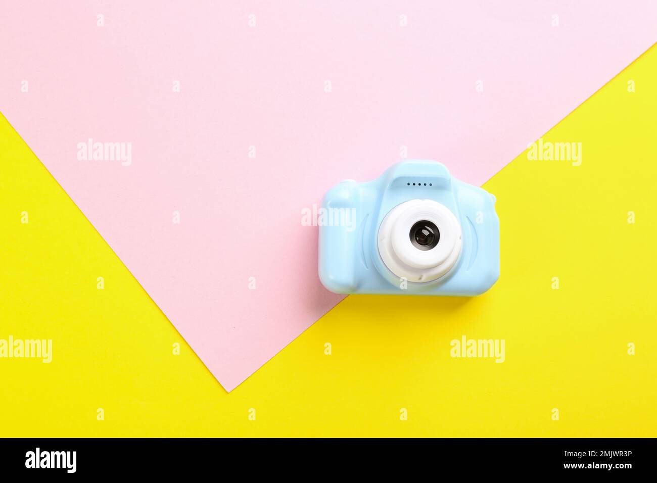 Light blue toy camera on color background, top view. Space for text ...