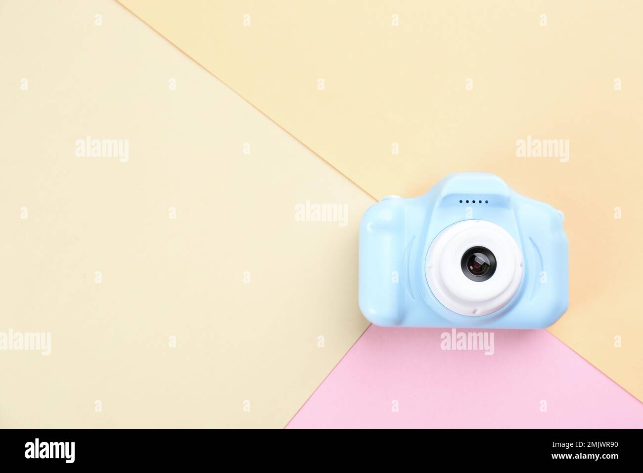 Light blue toy camera on color background, top view. Space for text ...
