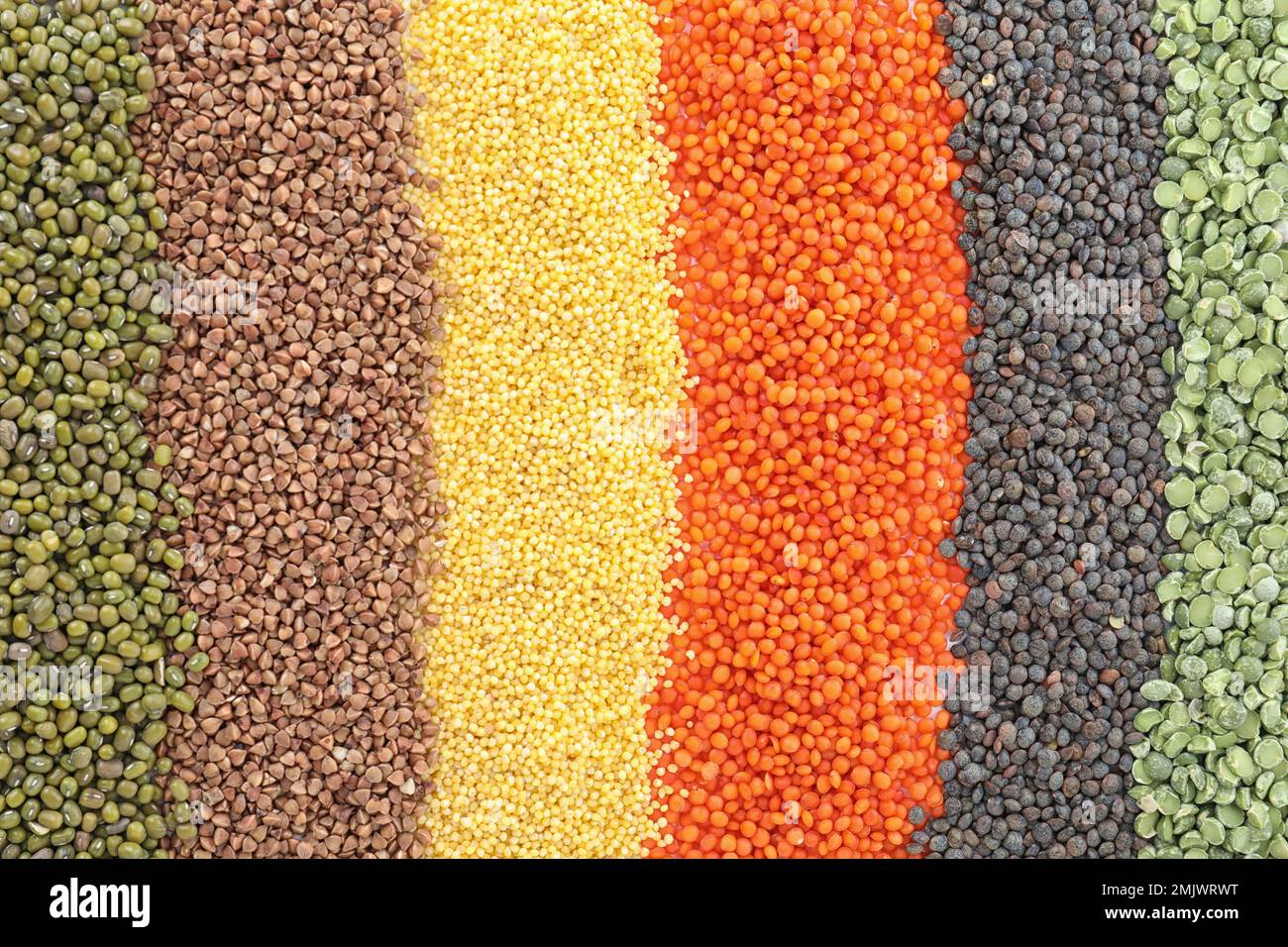 Different grains and cereals as background, top view Stock Photo - Alamy