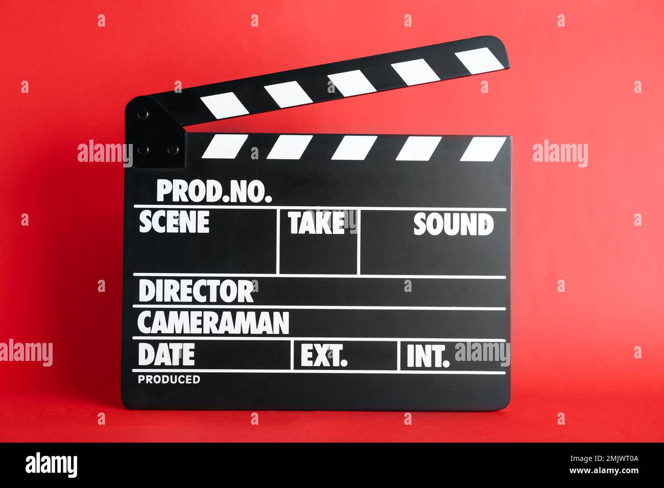 Clapper board on red background. Cinema production Stock Photo - Alamy