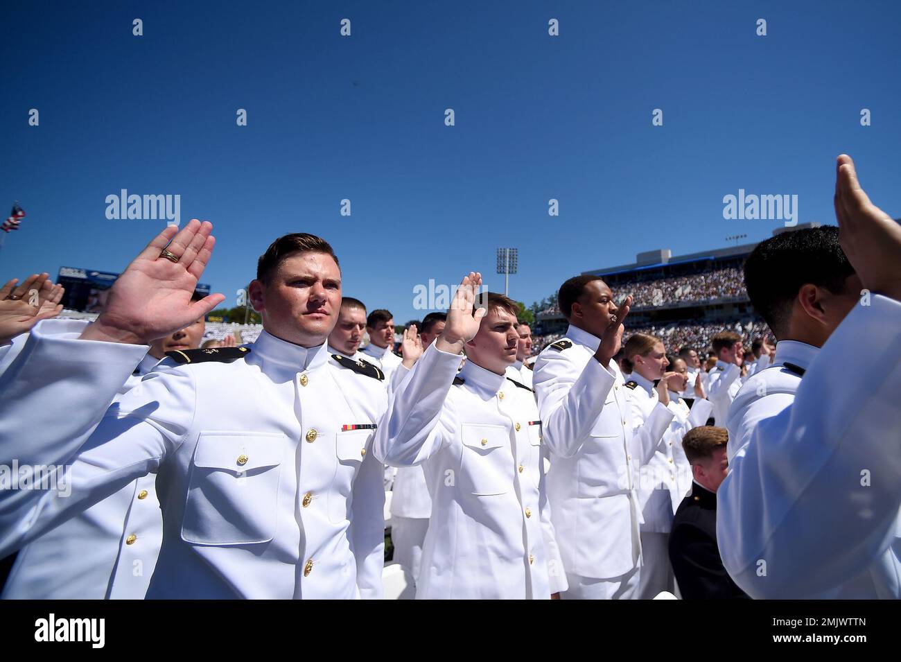 U.S. Naval Academy midshipmen raise their right hands as they are ...