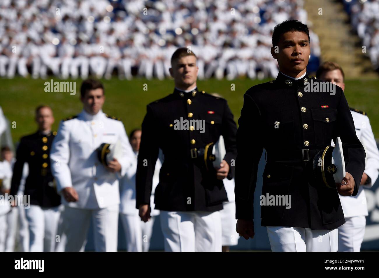Graduating U.S Naval Academy midshipmen walk into the academy's ...