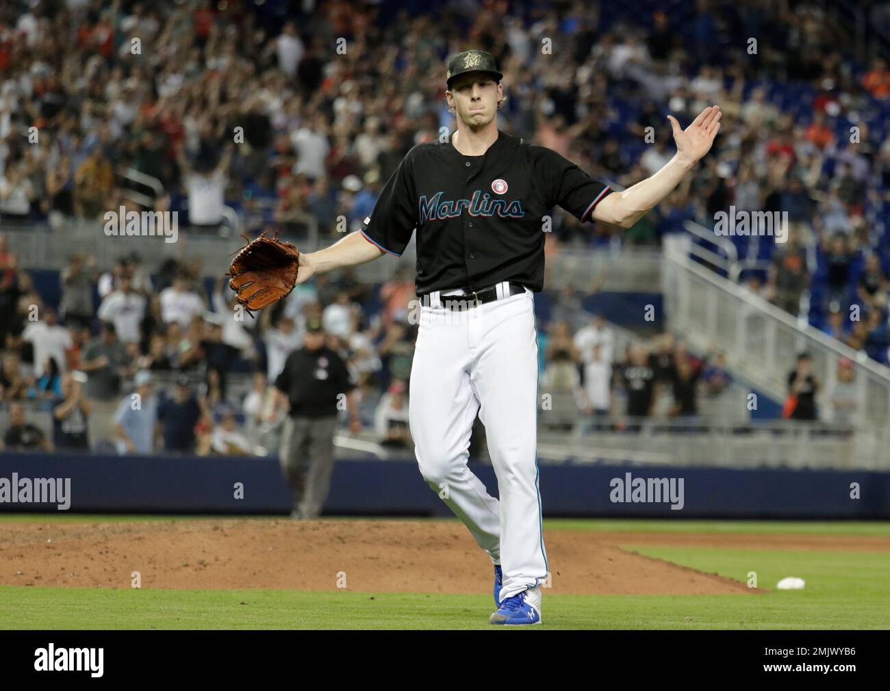 Miami Marlins relief pitcher Adam Conley reacts after the final out in ...