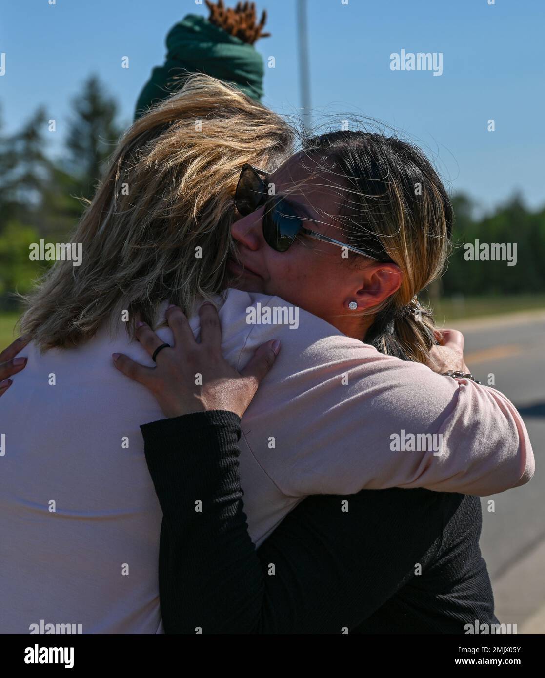 Volunteers from Minot Air Force Base embrace after placing ceremonial ...