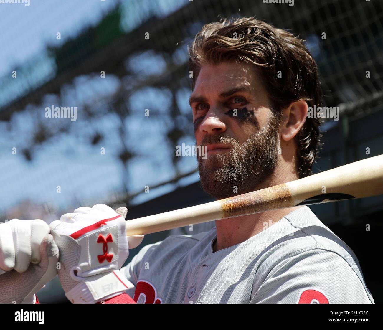 Philadelphia Phillies' Bryce Harper looks to the field from the dugout ...