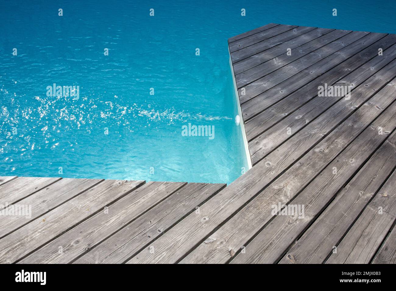 modern blue swimming pool with exotic wood terrace in teak wooden ...