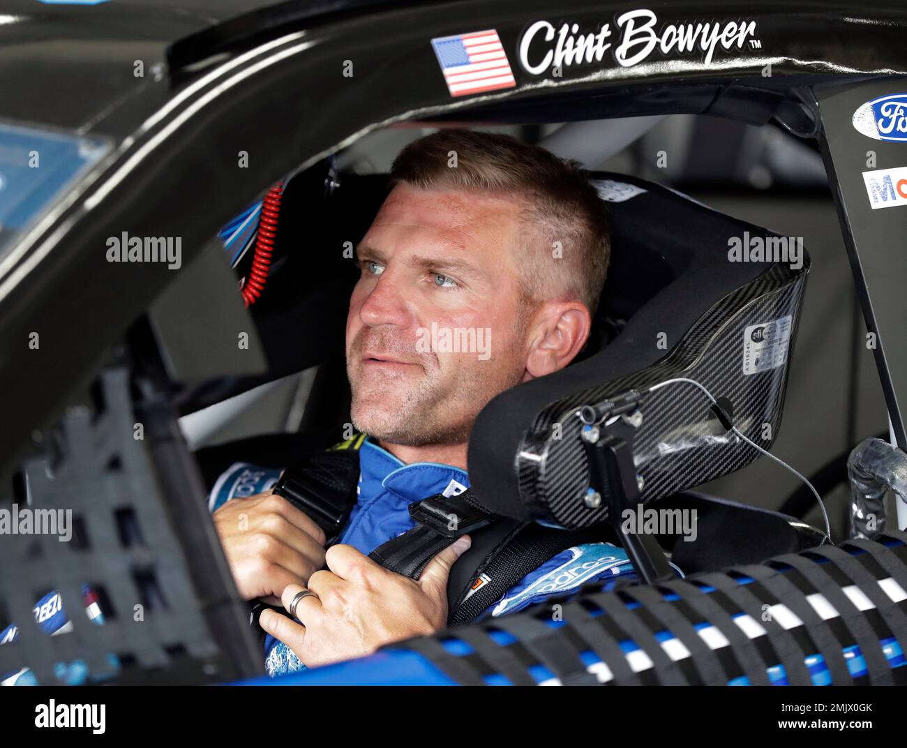 Clint Bowyer waits in his car before practice for Sunday's NASCAR Coca ...