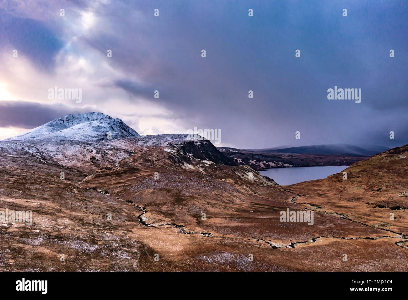 Aerial view of the snow covered Mount Errigal, the highest mountain in ...