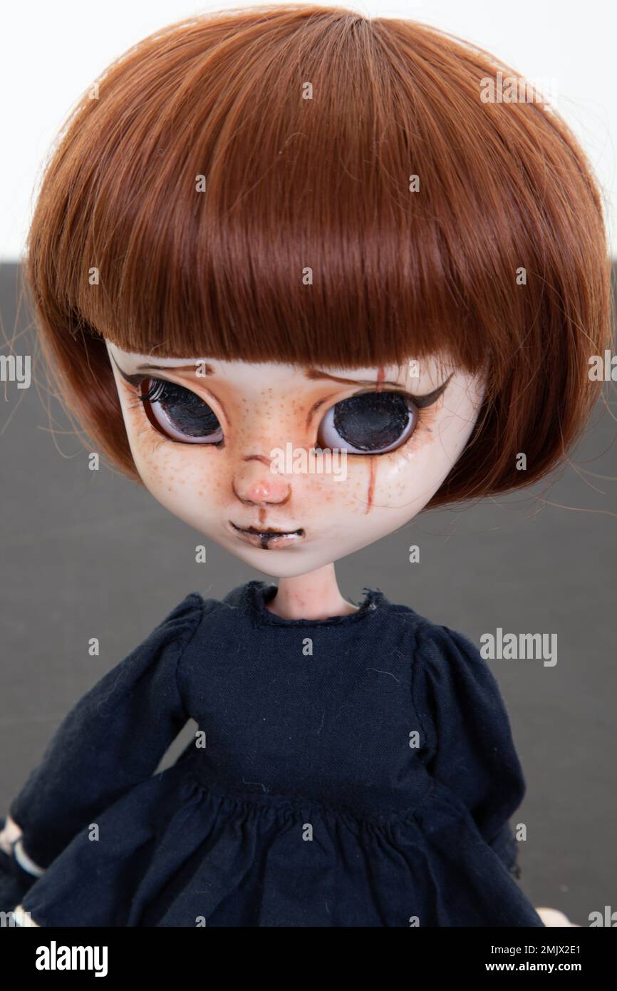 girl doll red hairs portrait in grey white background Stock Photo - Alamy