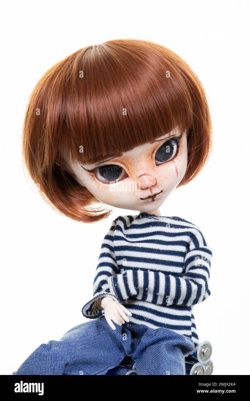 pretty doll red hairs in jeans sit in white background Stock Photo - Alamy