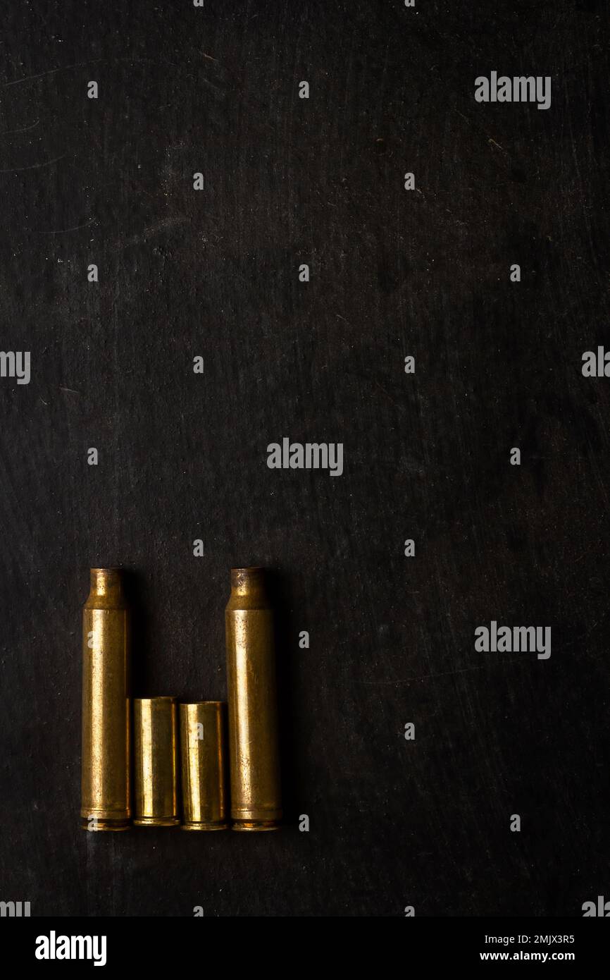 Empty bullet cartridges lying on the black background Stock Photo - Alamy