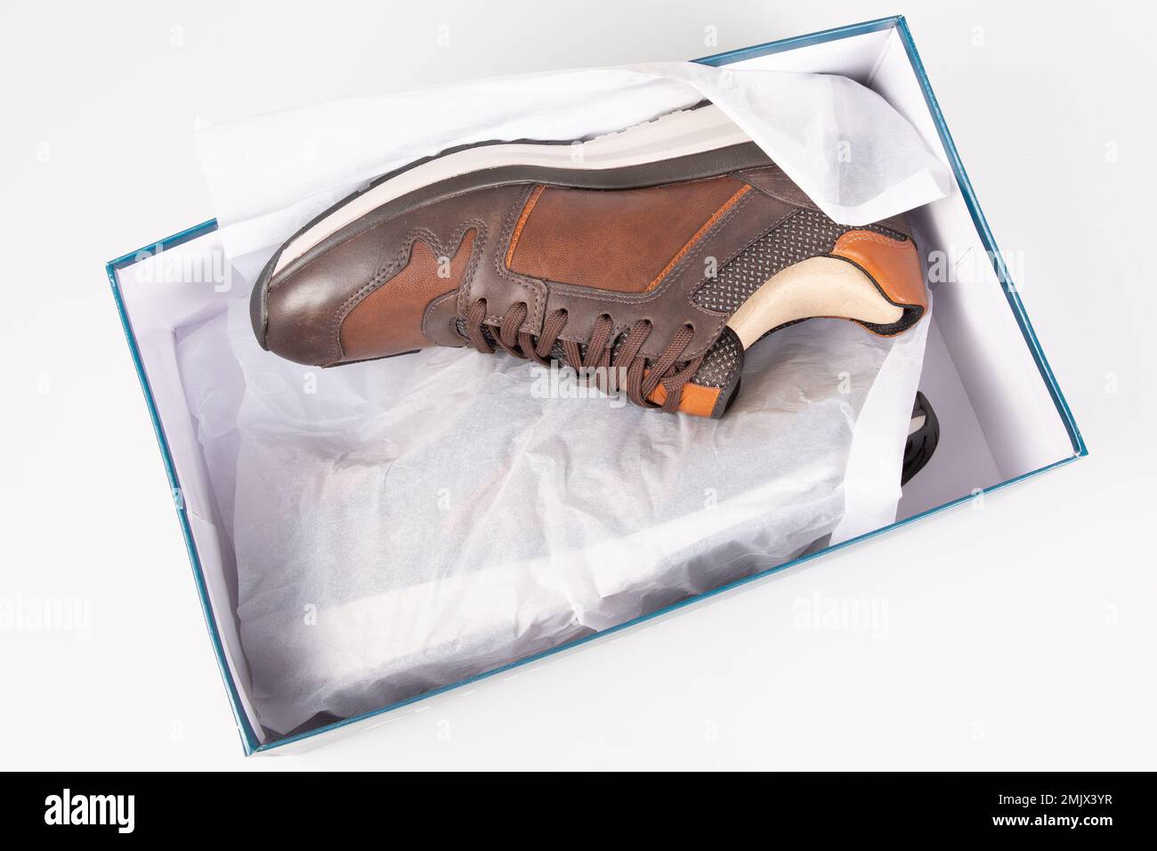 brown sneakers pair men on white paper box Stock Photo - Alamy