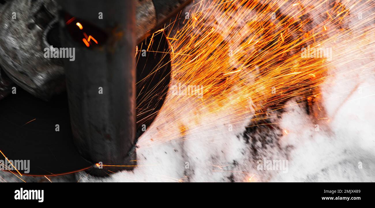 An angle grinder works, sparks stream close up photo Stock Photo - Alamy