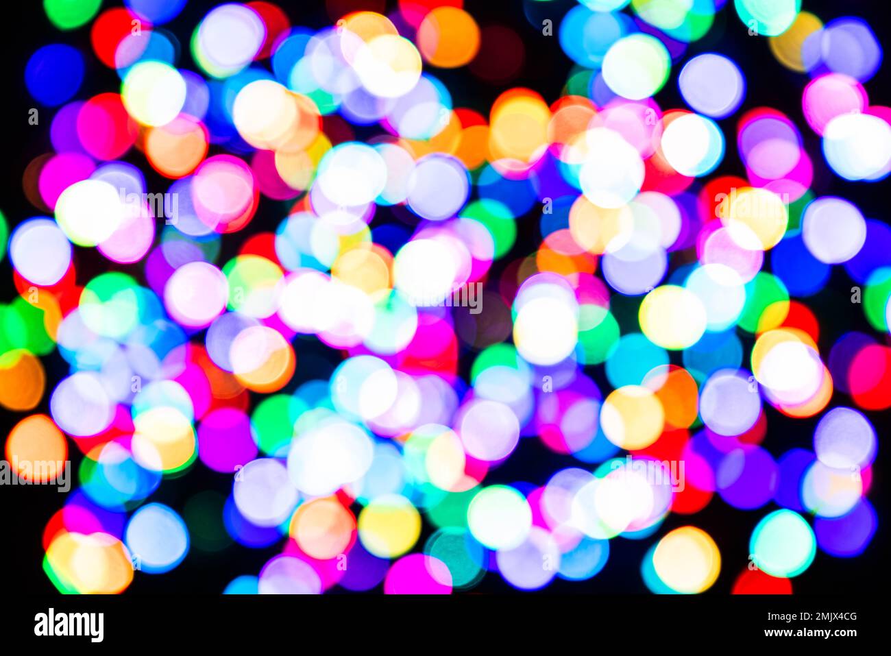 Multi-colored circles of light on a black background. Colourful bokeh ...