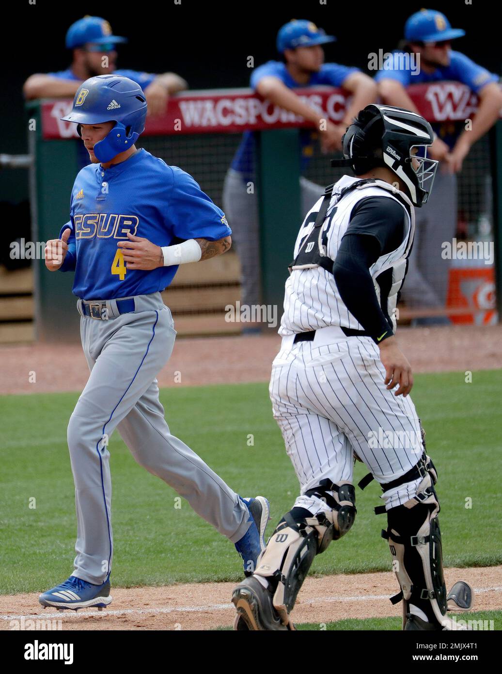 Cal State Bakersfield's Evan Berkey (4) scores on a base hit by Eric ...