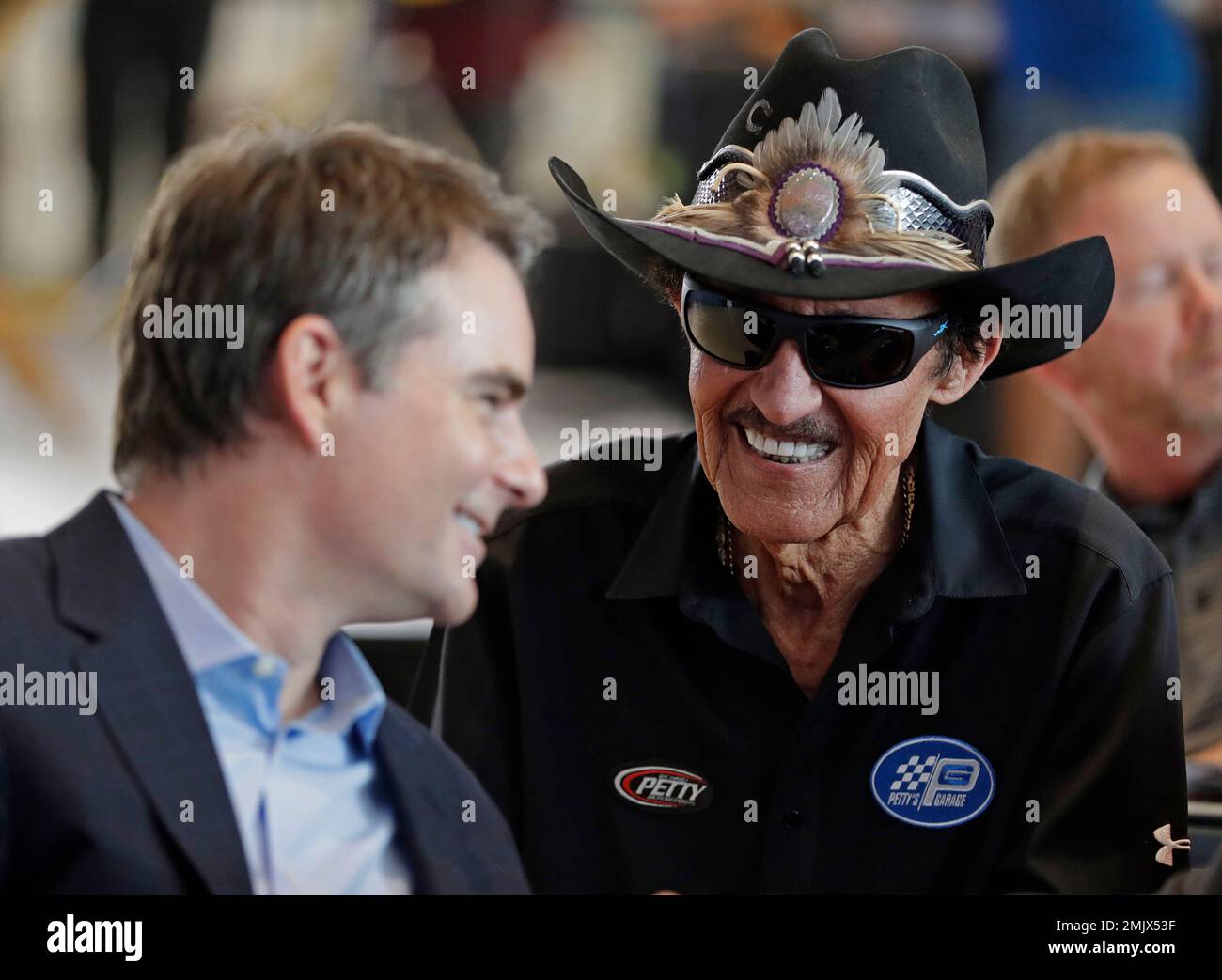Richard Petty, right, and Jeff Gordon smile while talking during NASCAR ...