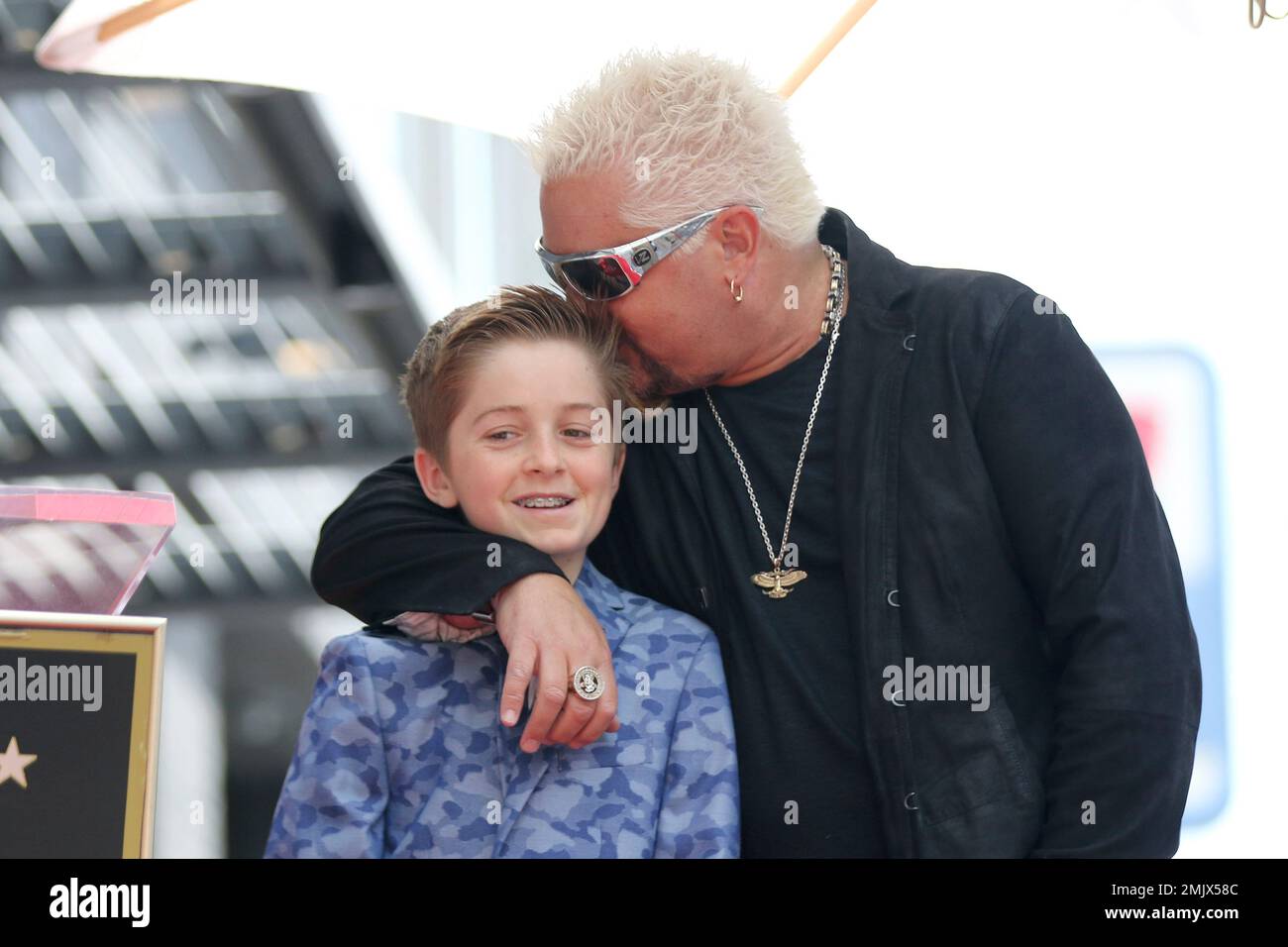 Guy Fieri, right, kisses his son Ryder Fieri at a ceremony honoring Guy ...