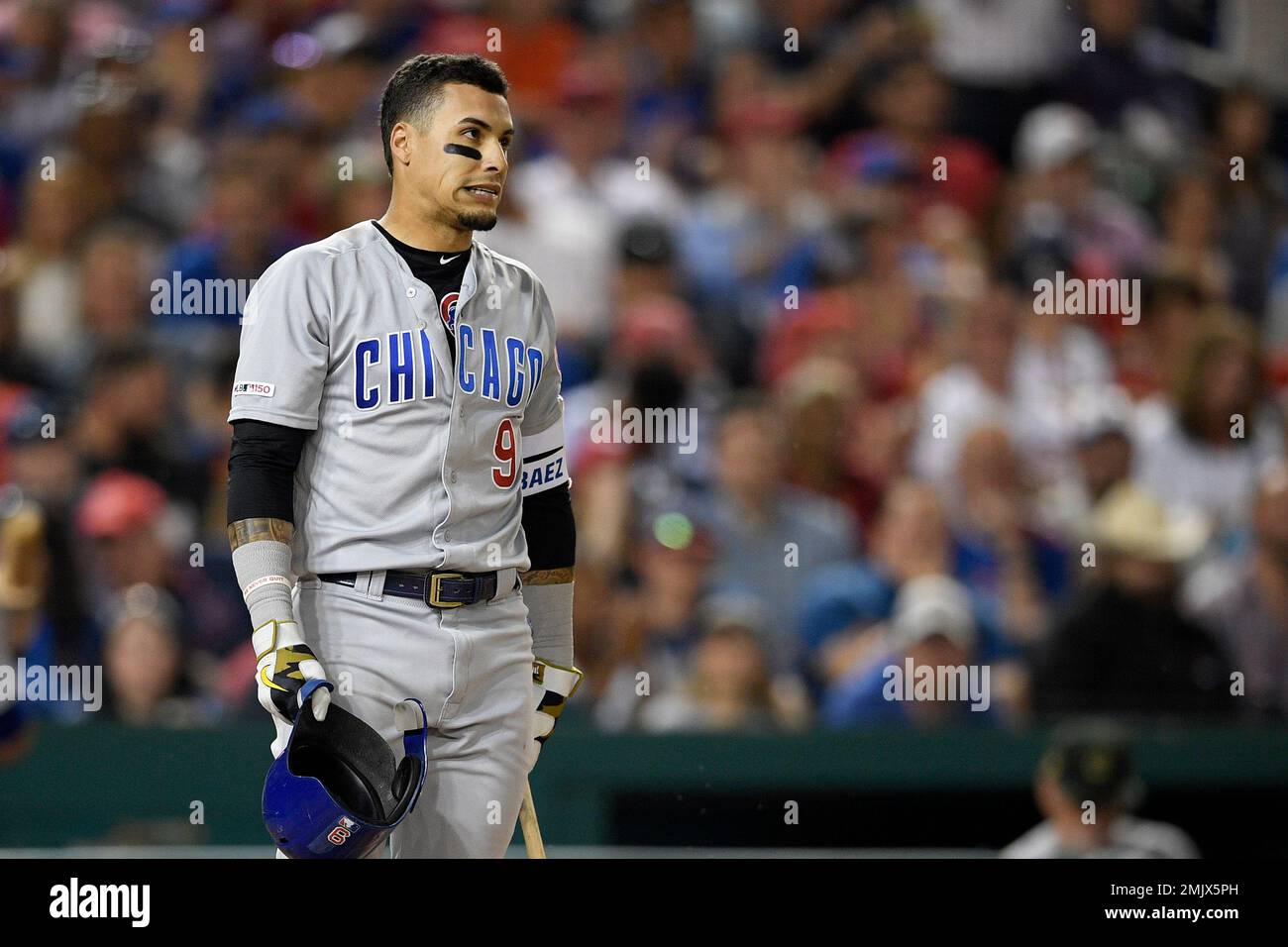 Chicago Cubs' Javier Baez stands on the field after he batted during a ...