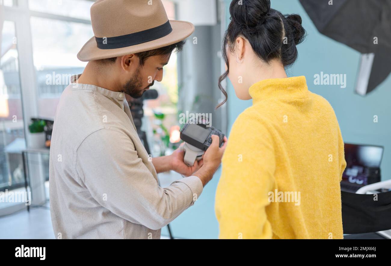 Photography, camera and photographer talking to a model while looking ...