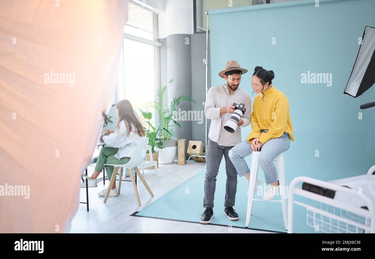 Photography, camera and photographer talking to a model to choose a image from the photoshoot in ...