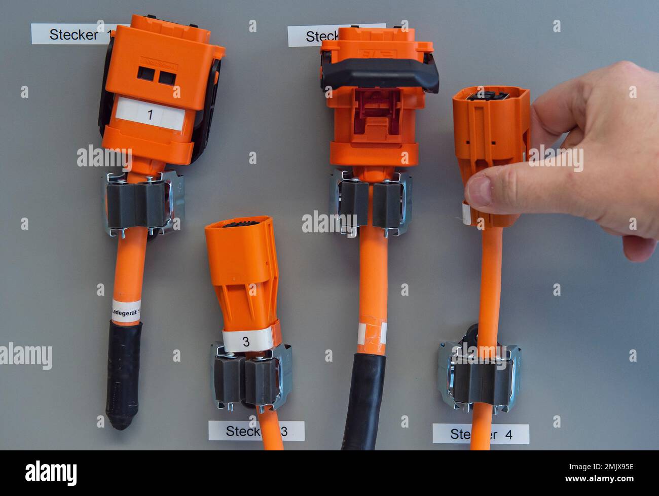 In this Tuesday, May 14, 2019 photo a worker fixes high-voltage plugs ...