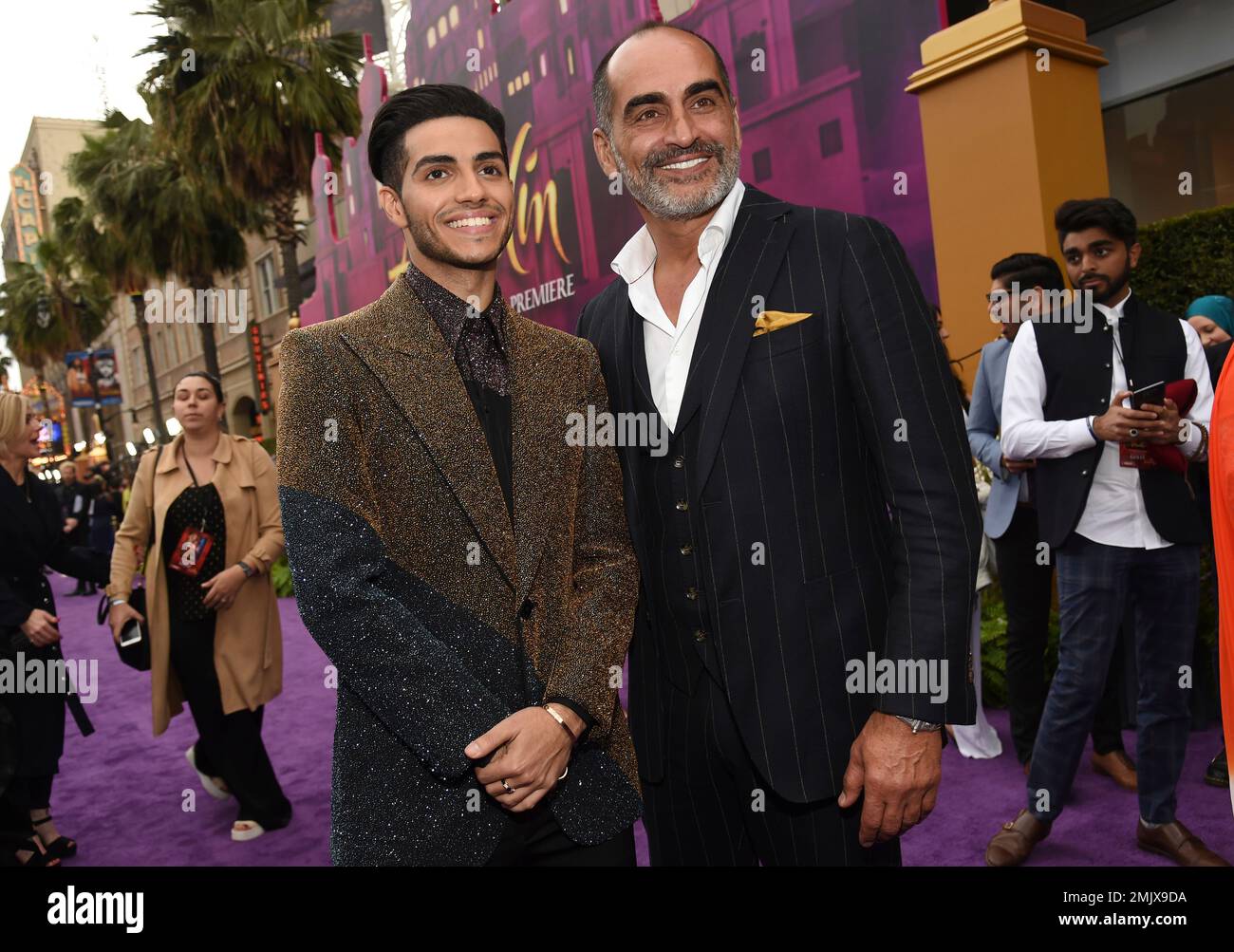 Mena Massoud, left, and Navid Negahban, cast members in "Aladdin," pose ...