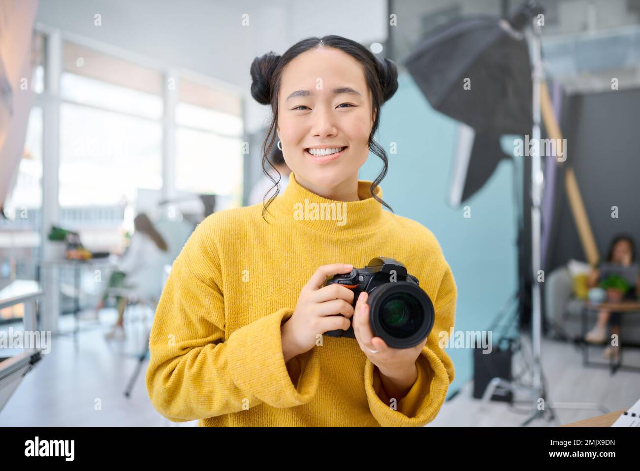 Smile, camera and portrait of a photographer working at a studio for a ...