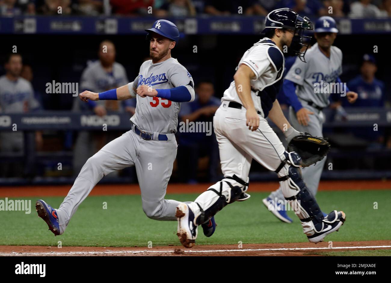 Los Angeles Dodgers' Cody Bellinger (35) scores behind Tampa Bay Rays ...