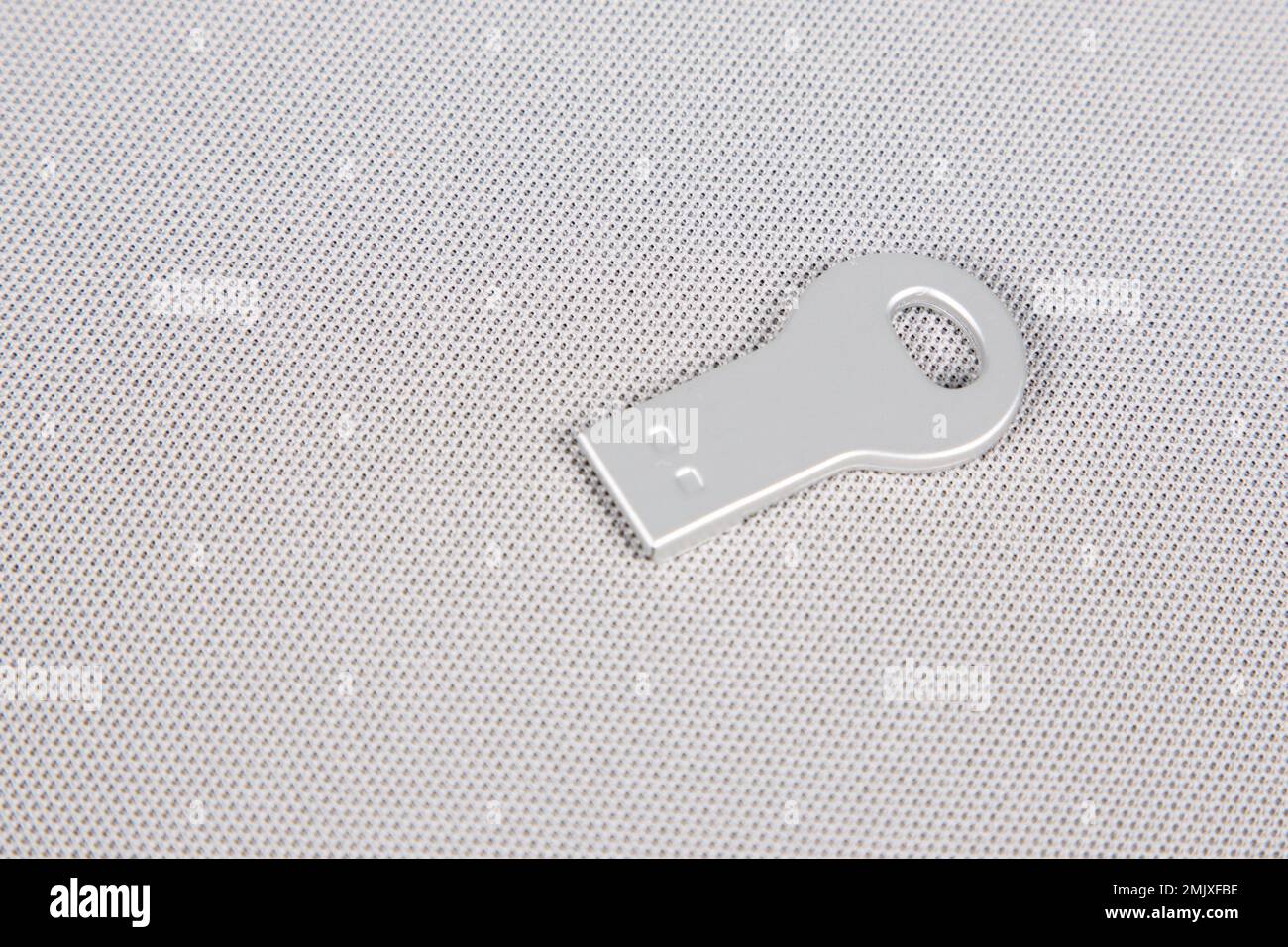 metal silver grey key USB flash drive on white desk gray background ...