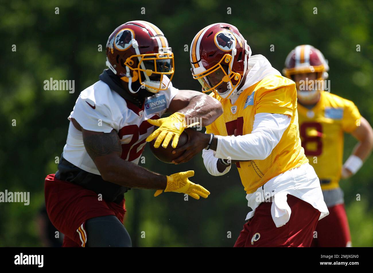 Washington Redskins quarterback Dwayne Haskins Jr., right, hands off to ...