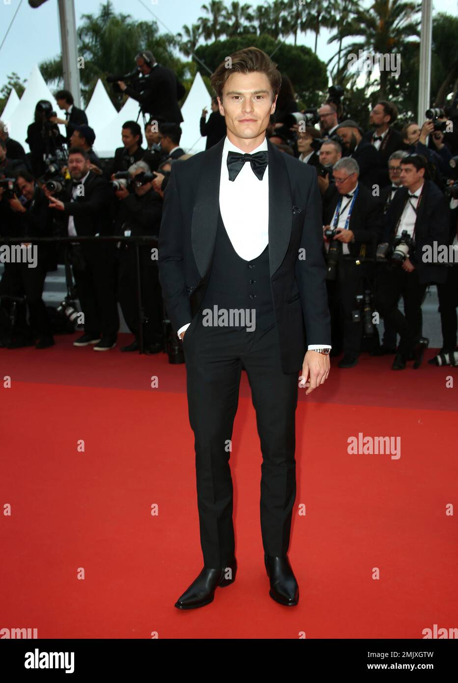 Model Oliver Cheshire poses for photographers upon arrival at the ...