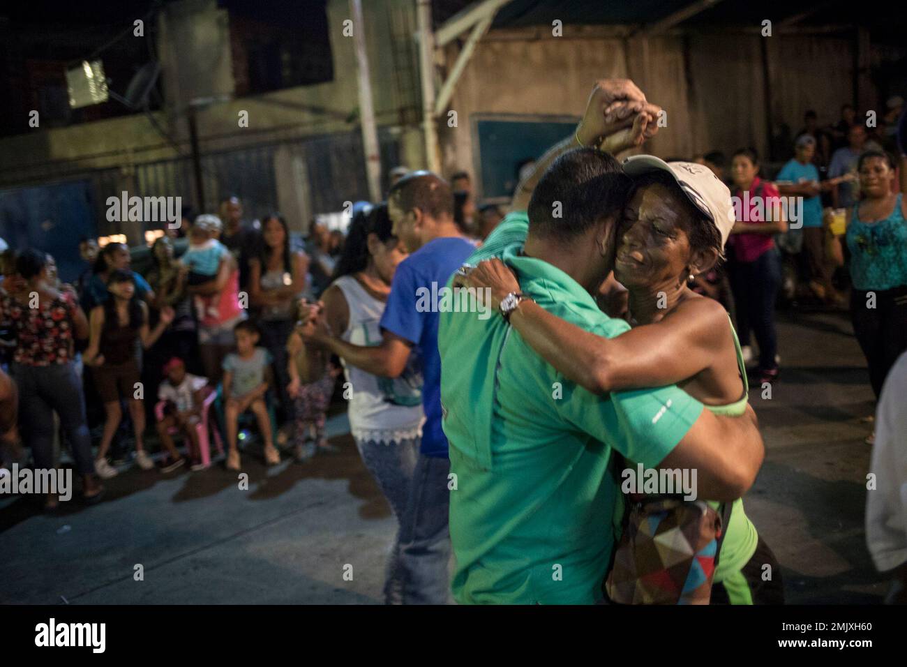 A couple dances during a Mother's Day block party in Caracas, Venezuela ...