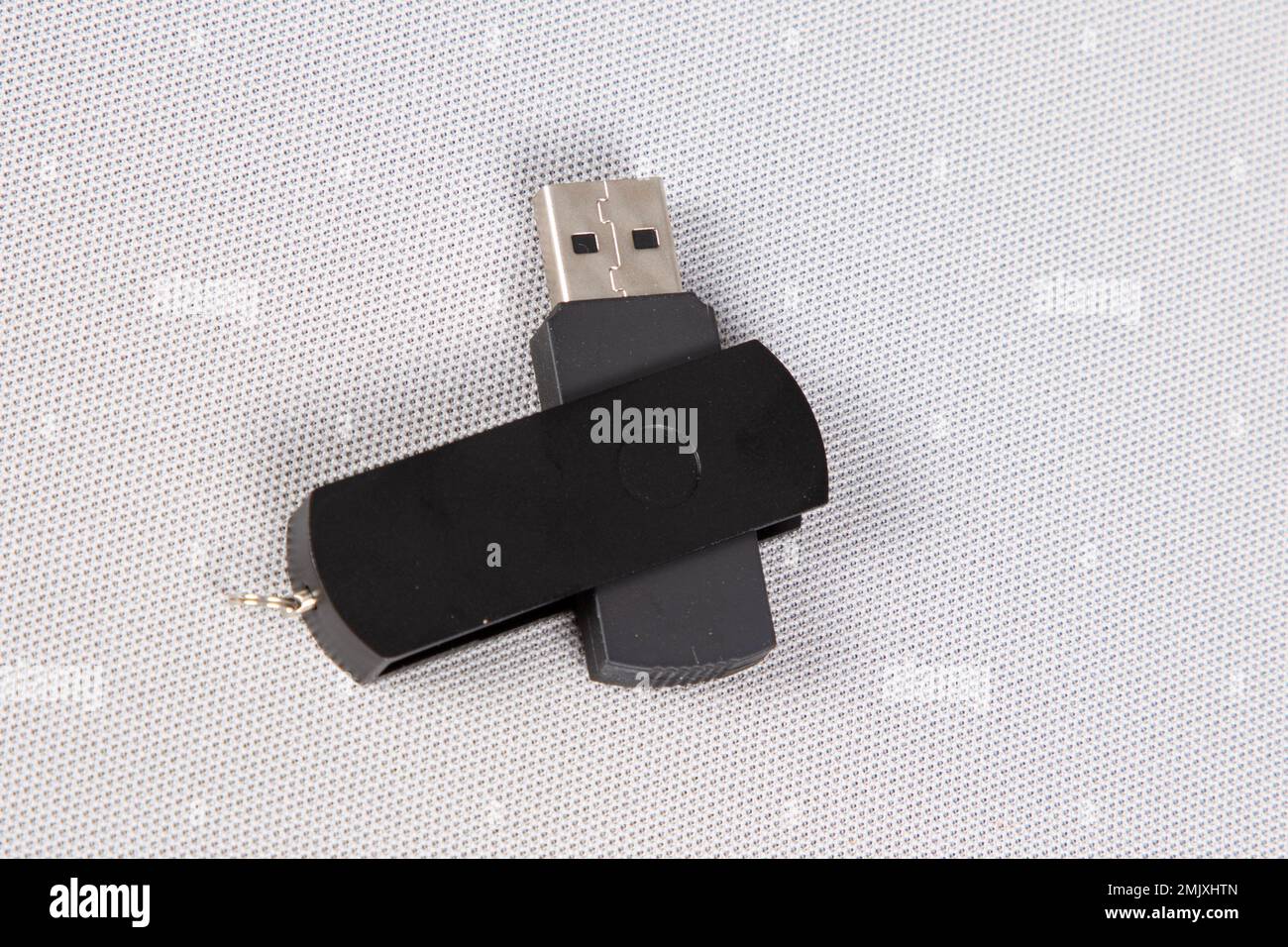black usb flash drive lip turn open on grey background Stock Photo - Alamy