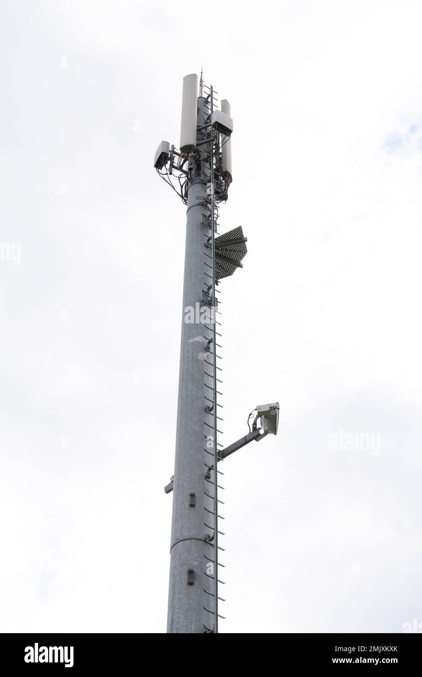 Communication steel tower against cloudy sky background Stock Photo - Alamy