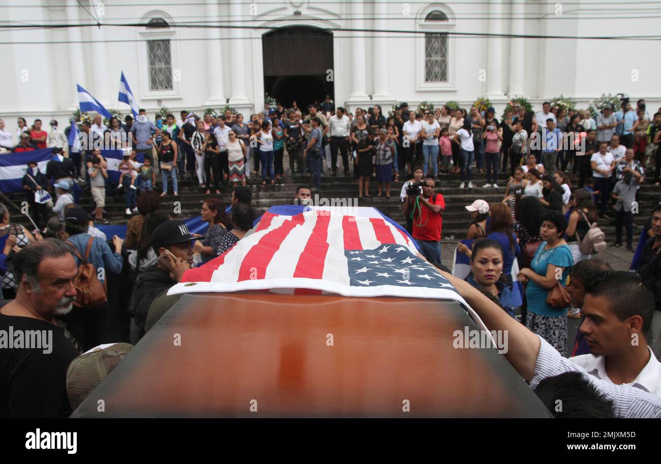 The U.S. flag-covered coffin of Eddy Montes Praslin is carried to a ...