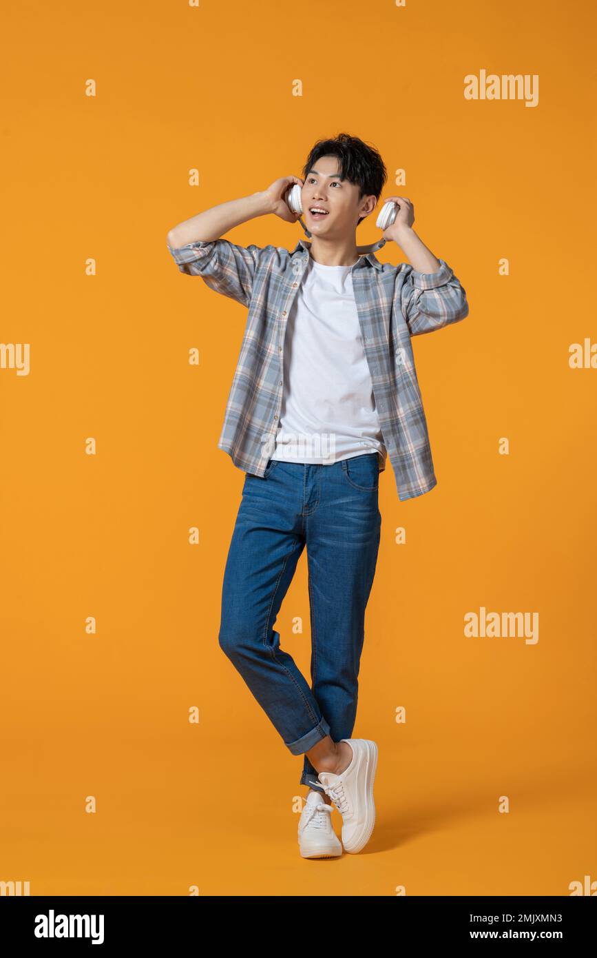 Fashionable young men listen to music Stock Photo - Alamy