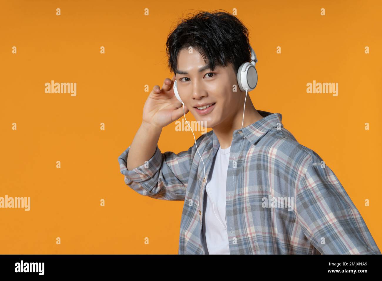 Fashionable young men listen to music Stock Photo - Alamy