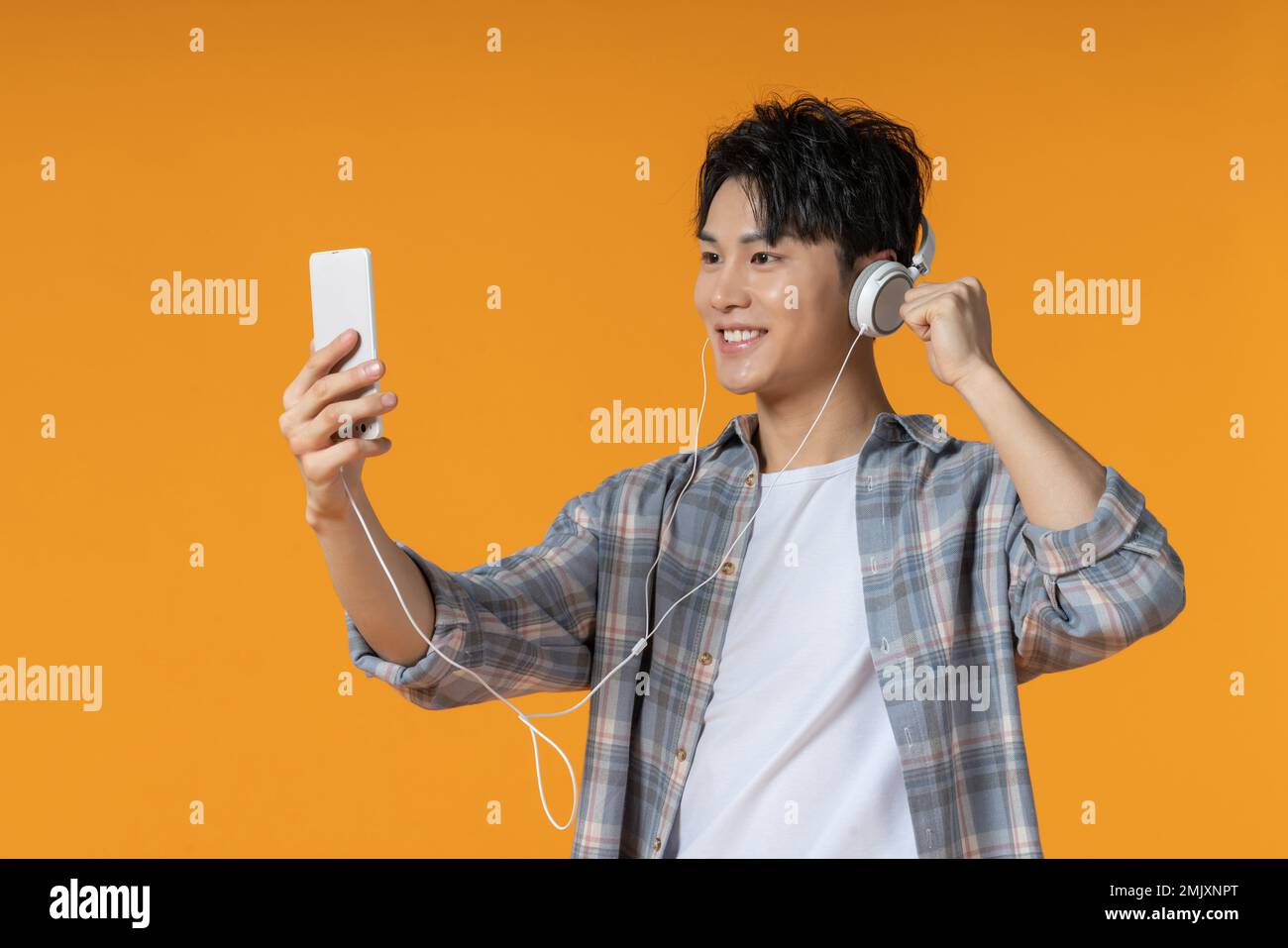 Fashionable young men use a mobile phone Stock Photo - Alamy