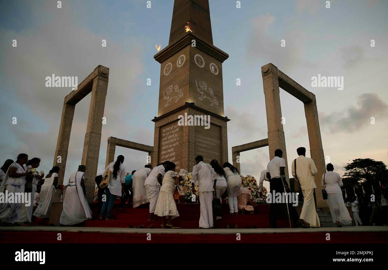 Family members of fallen Sri Lankan soldiers place floral tributes ...